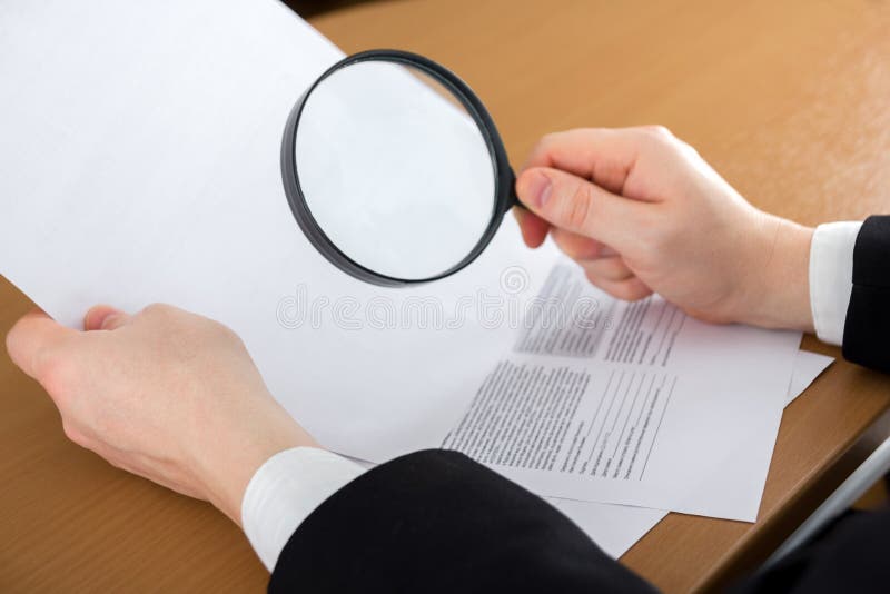 Business Man Looking in Documents with Magnifying Glass. Stock Image ...