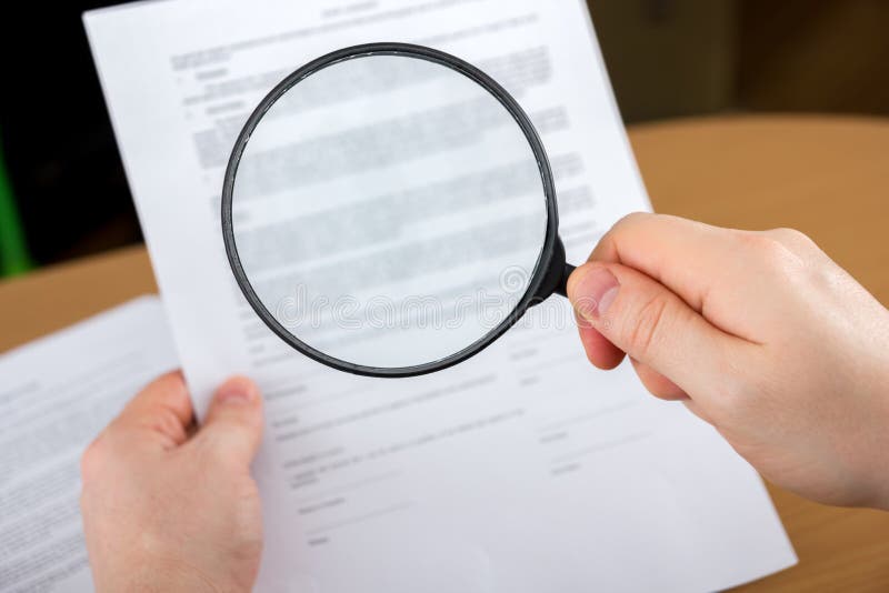 Business Man Looking in Documents with Magnifying Glass. Stock Photo ...