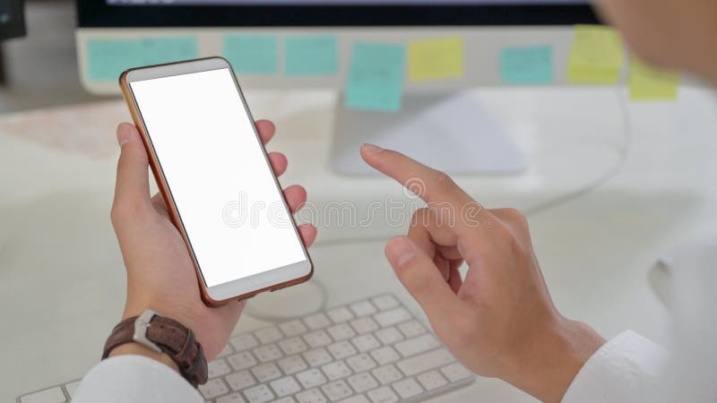 A Business Man Looking for Information on a Smartphone while Working ...