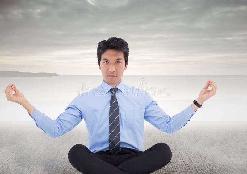 Business Man Meditating on Concrete Ground Against Grey Sky Stock Image ...