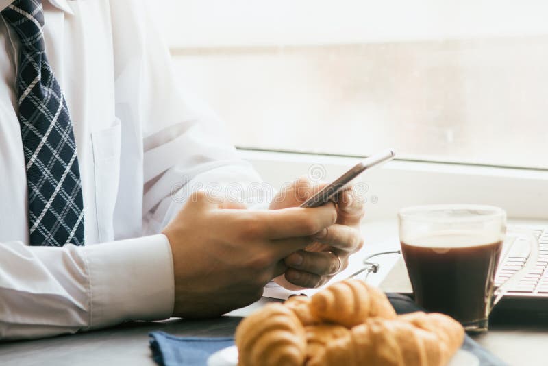 Business Man in Office Lobby Using Laptop and Cell Phone Stock Photo ...