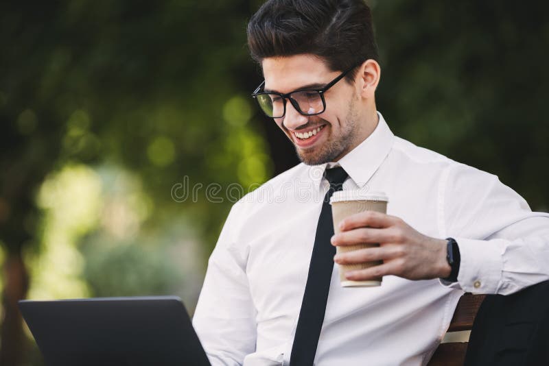 Business Man Outdoors in the Park Using Laptop Computer Drinking Coffee ...