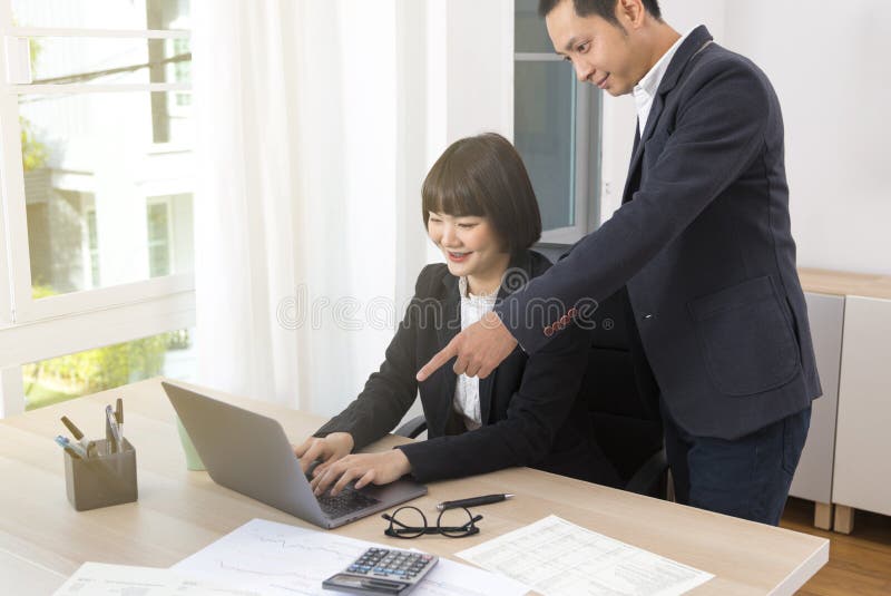 Business Man Pointing Finger at Computer while Woman Worker Working and ...