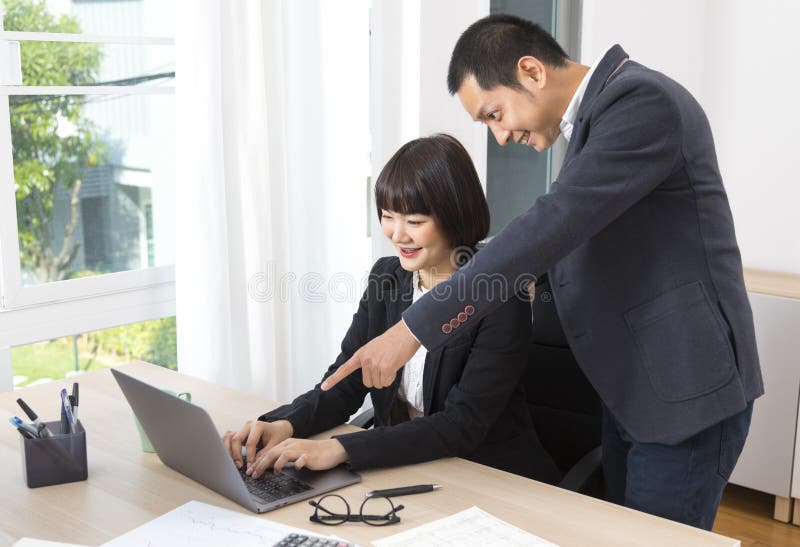 Business Man Pointing Finger at Computer while Woman Worker Working and ...