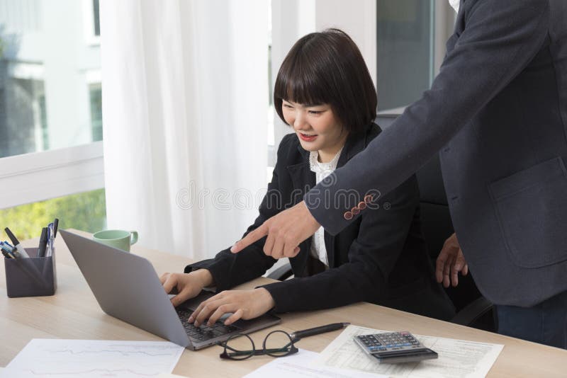 Business Man Pointing Finger at Computer while Woman Worker Working and ...