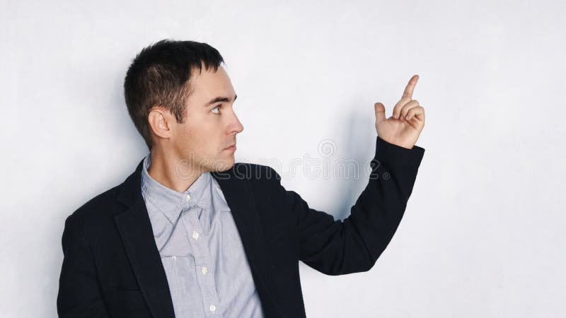 Business Man Points with Fingers in the Right Side. Young Man in a ...