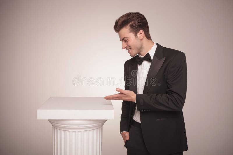 Business Man Presenting Something on a White Column. Stock Photo ...