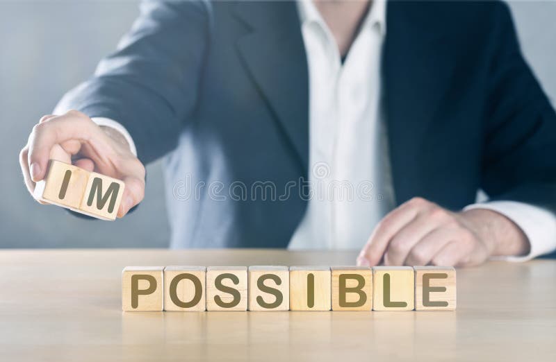 Business Man Puts Away First Two Letters from the Word Impossible, so ...