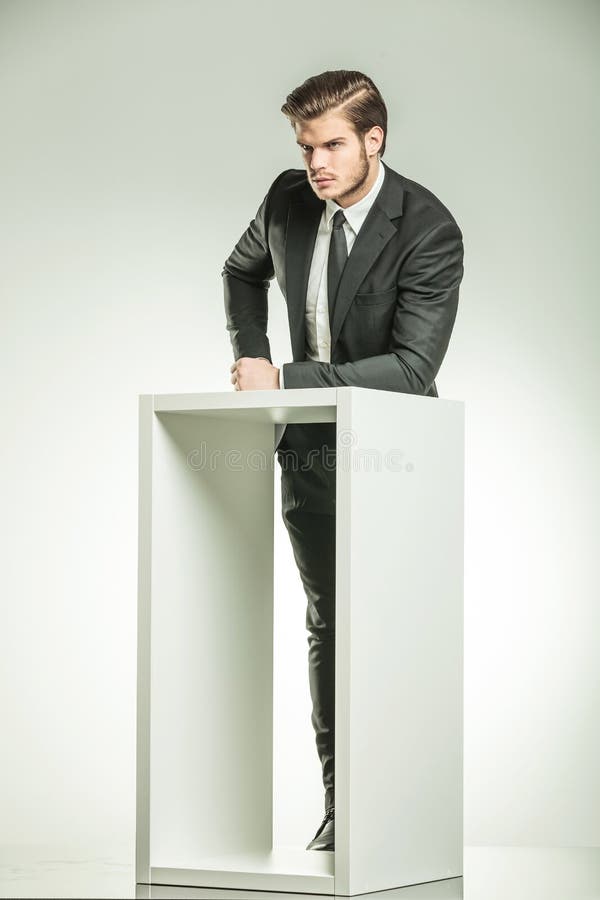 Business Man Resting His Arm on a White Modern Table Stock Image ...