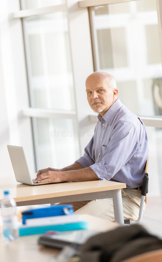 Man Seated Working on Laptop Computer. Stock Photo - Image of macintosh ...