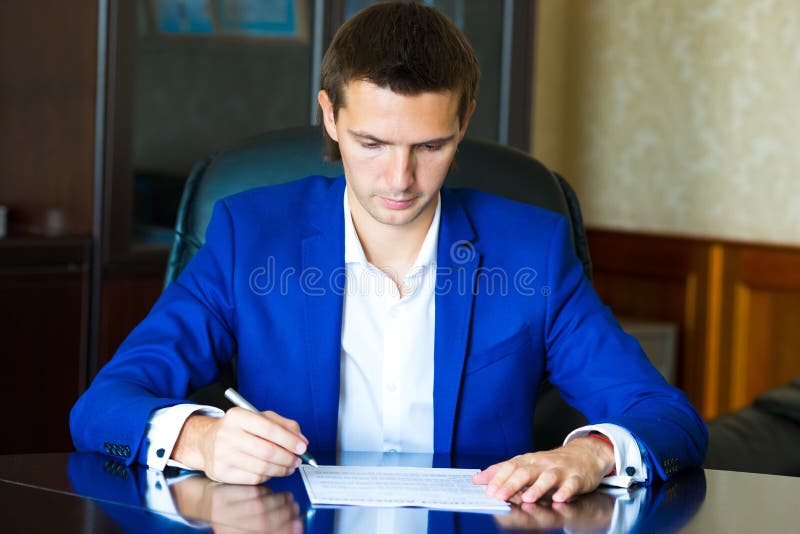 Business Man Signing a Contract in Big Office Stock Photo - Image of ...