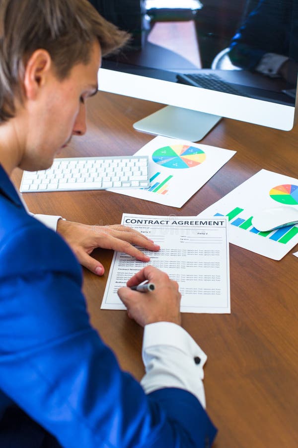 Business Man Signing a Contract in Big Office Stock Photo - Image of ...