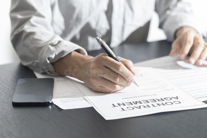 Close Up of Business Manager Signing Document on Table. Stock Photo ...