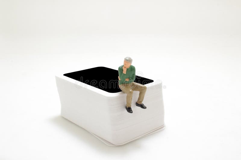 A Business Man Sit on Sheets of Card Stock Photo - Image of corporate ...