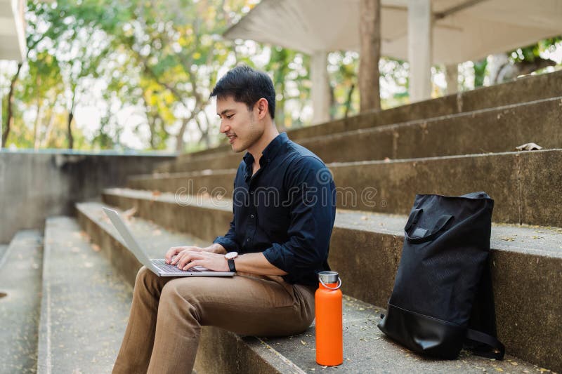 Business Man Sitting on Bench and Working Remotely on Project with ...