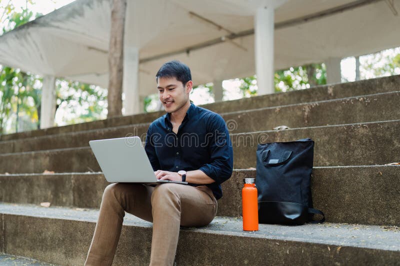 Business Man Sitting on Bench and Working Remotely on Project with ...