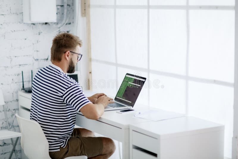 Business Man Sitting at Desk in Office and Looking at Open Laptop ...