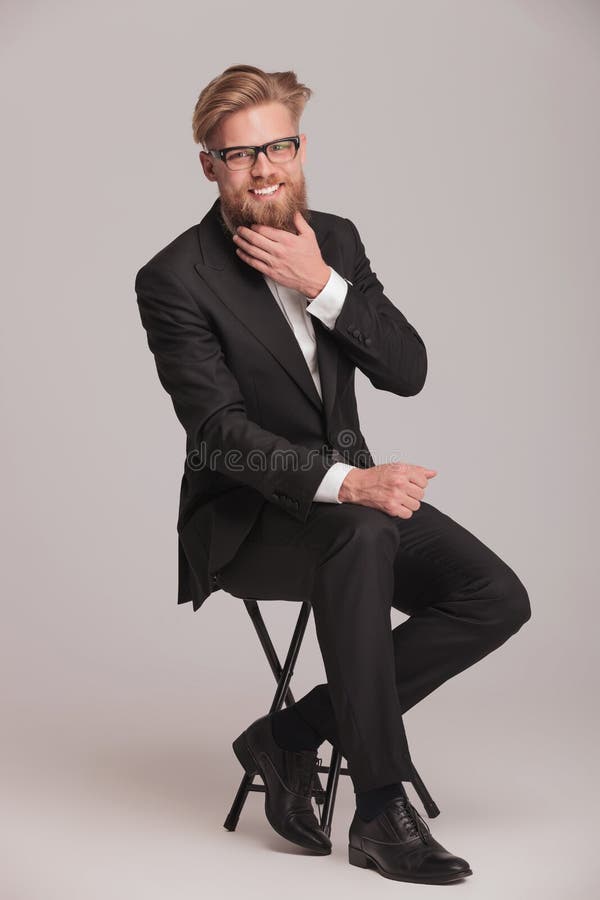 Business Man Sitting on a Stool while Fixing His Beard Stock Image ...