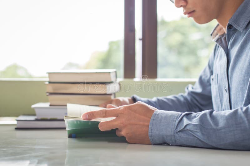 Business Man Sitting at a Table Reading a Book Stock Photo - Image of ...