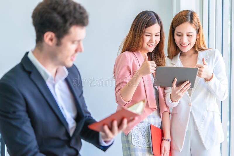 Business Man Taking Note in Front of Two Female Office Worker Stock ...