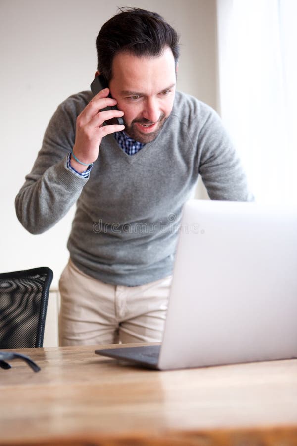 Business Man Talking on Phone and Looking at Computer Stock Image ...