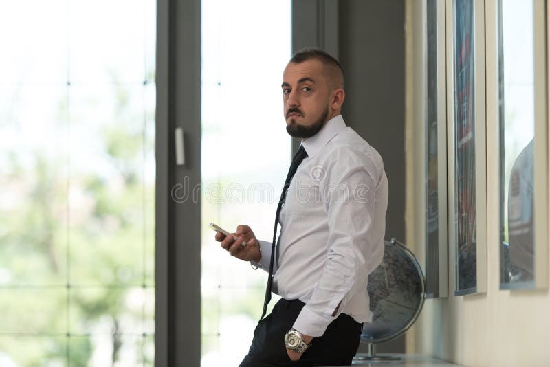Business Man Texting on Cellphone in Modern Office Stock Photo - Image ...
