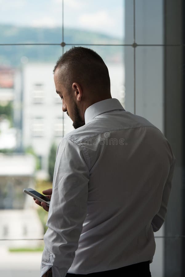 Business Man Texting on Cellphone in Modern Office Stock Photo - Image ...