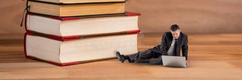 Business Man Using Computer on the Floor Next To a Pile of Books Stock ...