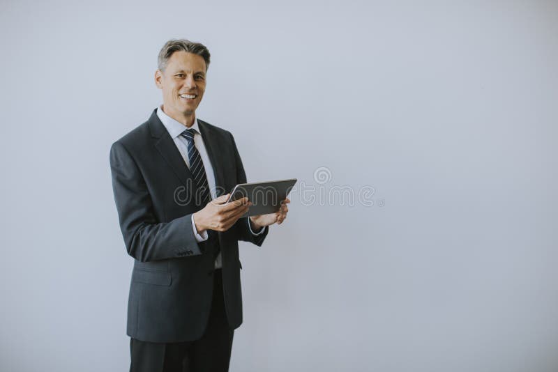 Business Man Using Digital Tablet by the Wall in the Office Stock Photo ...
