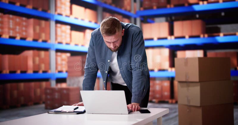 Business Man Using Laptop Computer in Warehouse Stock Photo - Image of ...