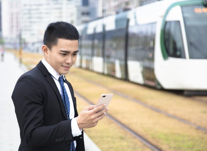 Businessman Using Smart Phone at Train Station Stock Photo - Image of ...