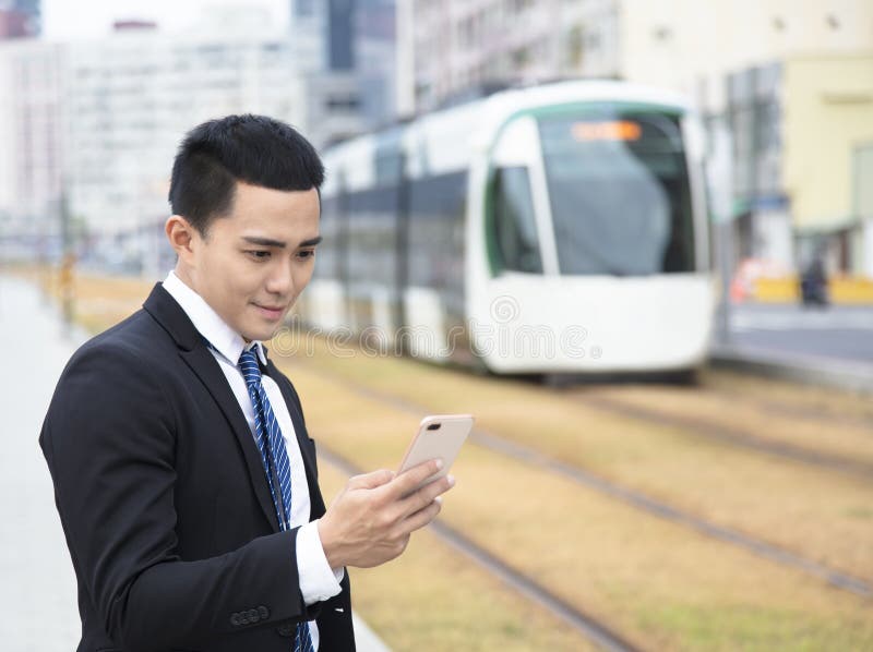 Businessman Using Smart Phone at Train Station Stock Photo - Image of ...