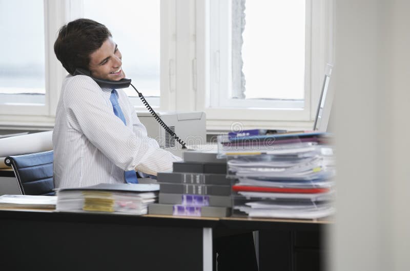 Business Man Using Telephone at Desk in Office Smiling Stock Photo ...
