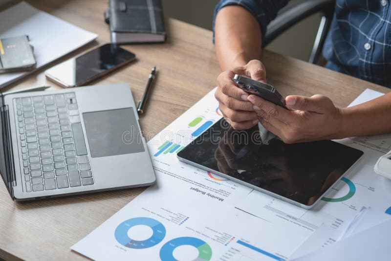A Business Man Who is Using Two Mobile Phones To Communicate with ...