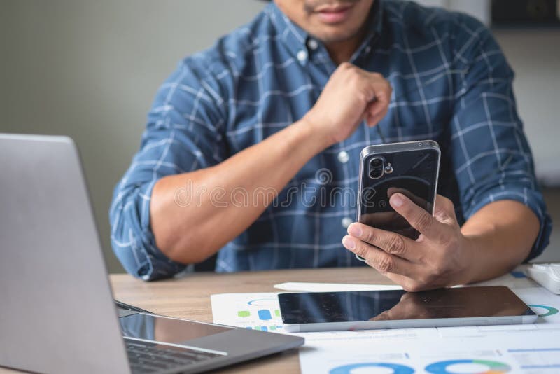 A Business Man Who is Using Two Mobile Phones To Communicate with ...