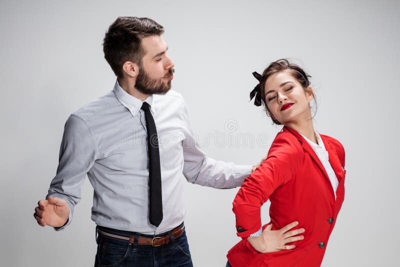 The Business Man And Woman Communicating On A Gray Background Stock