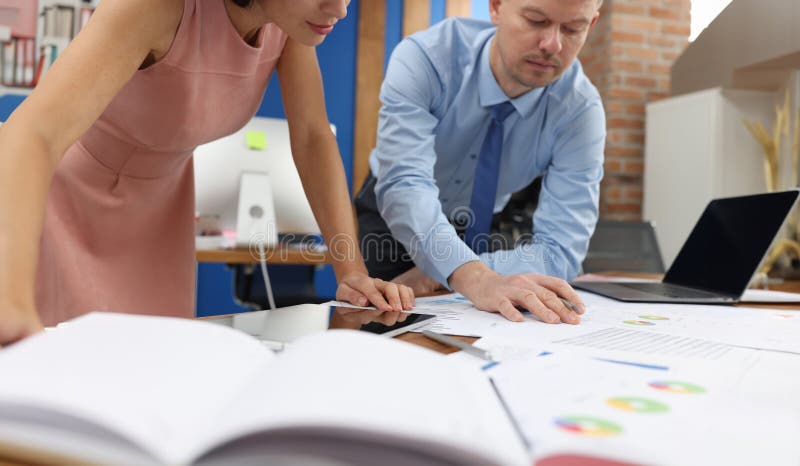 Business Man and Woman Studying Documents at Table in Office Closeup ...
