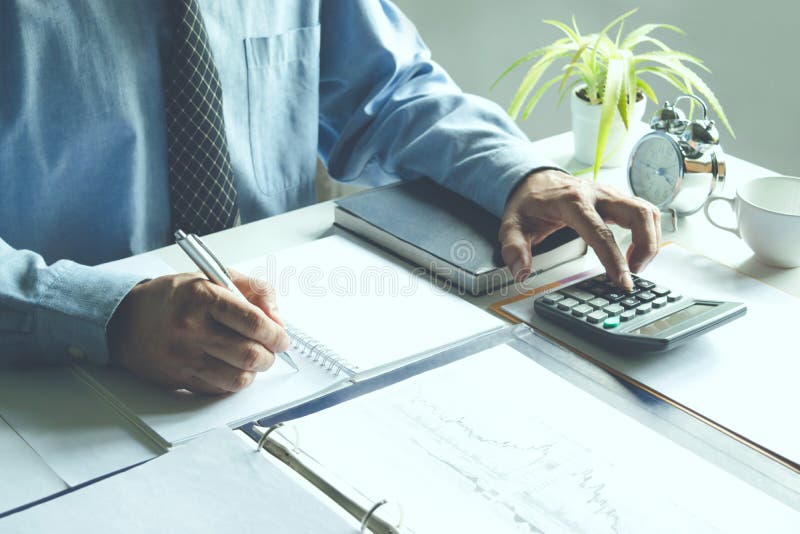 Business Man Work Writing Document and Putting Calculator on Tab Stock ...