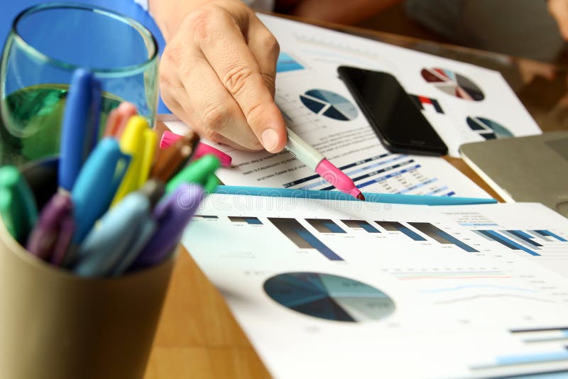 Business Man Working and Analyzing Financial Figures on a Graphs on a ...