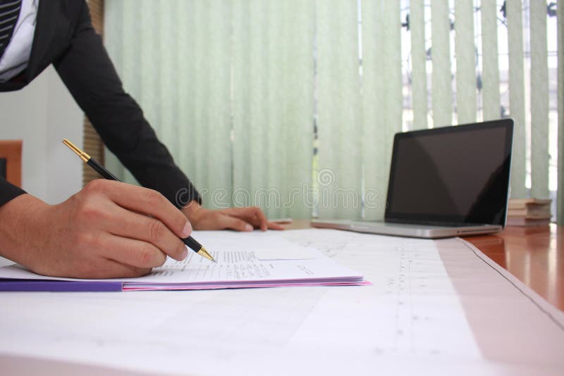 Business Man Working on Document and Blueprint at Office, Business ...