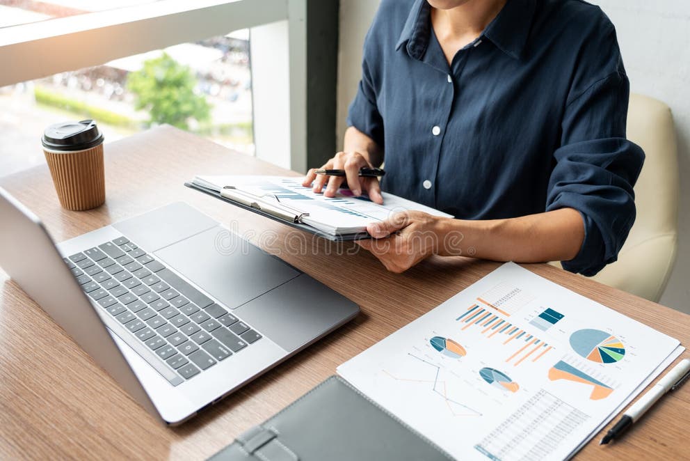 Business Man Working with Graph Data in Laptop and Documents on His ...