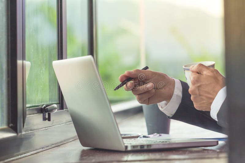 Business Man Working on Laptop Computer and Drinking Coffee. Stock ...