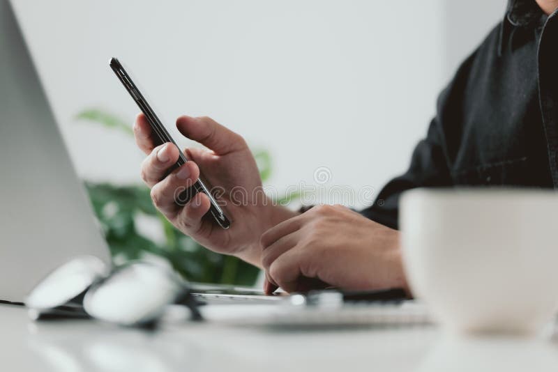 Casual Business Man Working on Laptop Computer and Using Mobile Phone ...