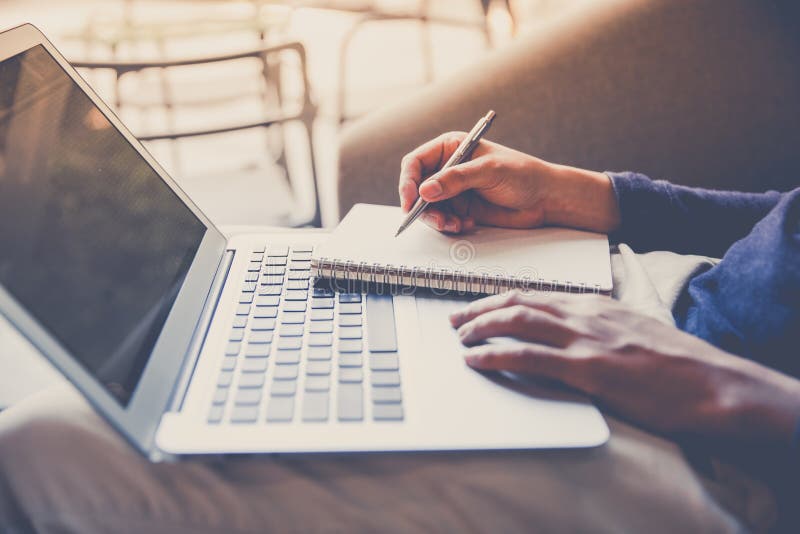 Business Man Working on Laptop Computer and Writing Notebook Stock ...