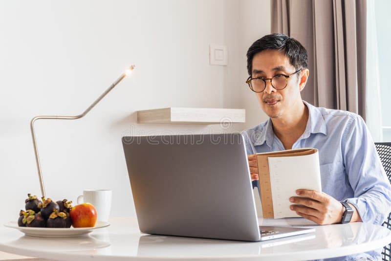 Business Man Working Laptop Holding Notebook in His Hand. Stock Image ...