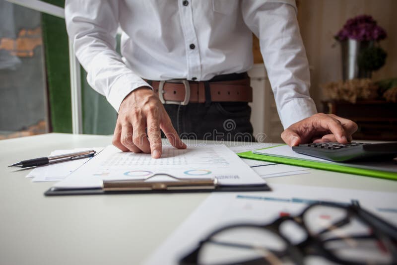 Business Man Working at Office with Calculator and Documents on His ...