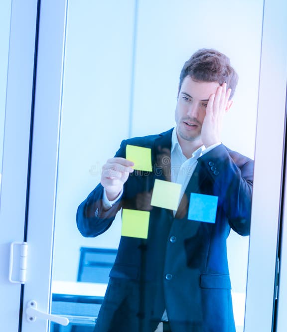 Business Man Writing Idea on To Post it Windows for Plan Stock Photo ...