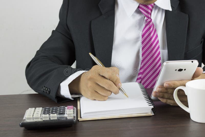 Business Man Writing on Notebook and Looking Work on Phone Stock Image ...
