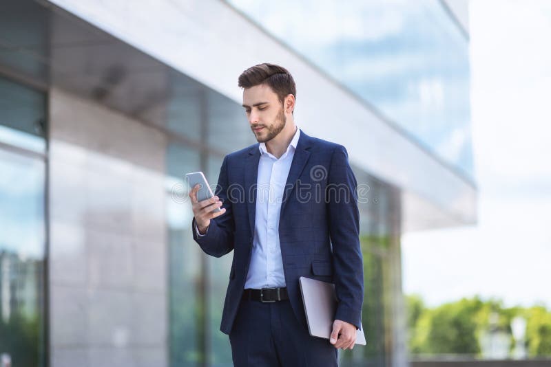 Business Manager with Mobile Phone and Tablet Computer Using Internet ...