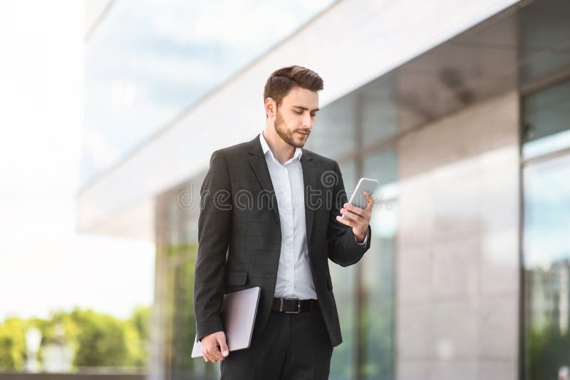 Business Manager with Mobile Phone and Tablet Computer Using Internet ...